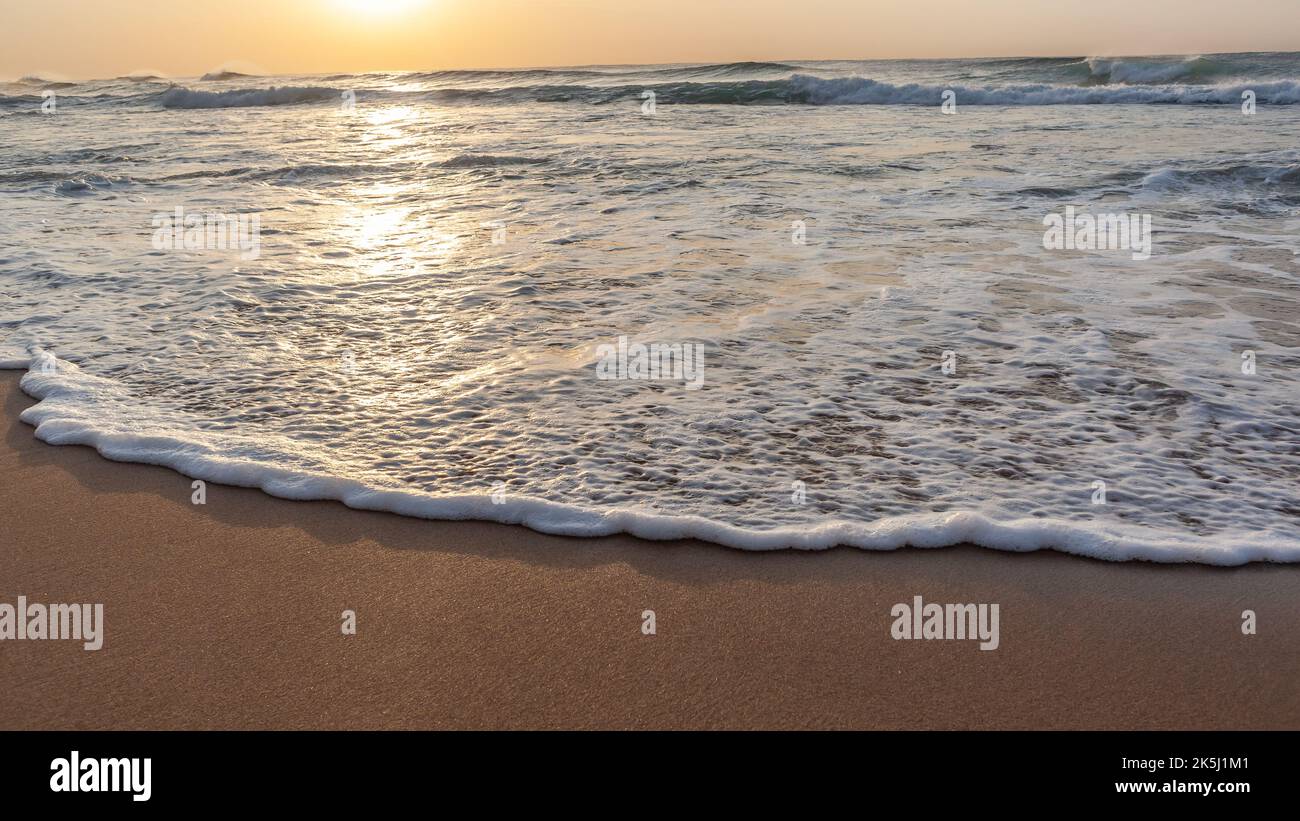 Beach morning wave wash up sand shoreline sea water sunlight ...