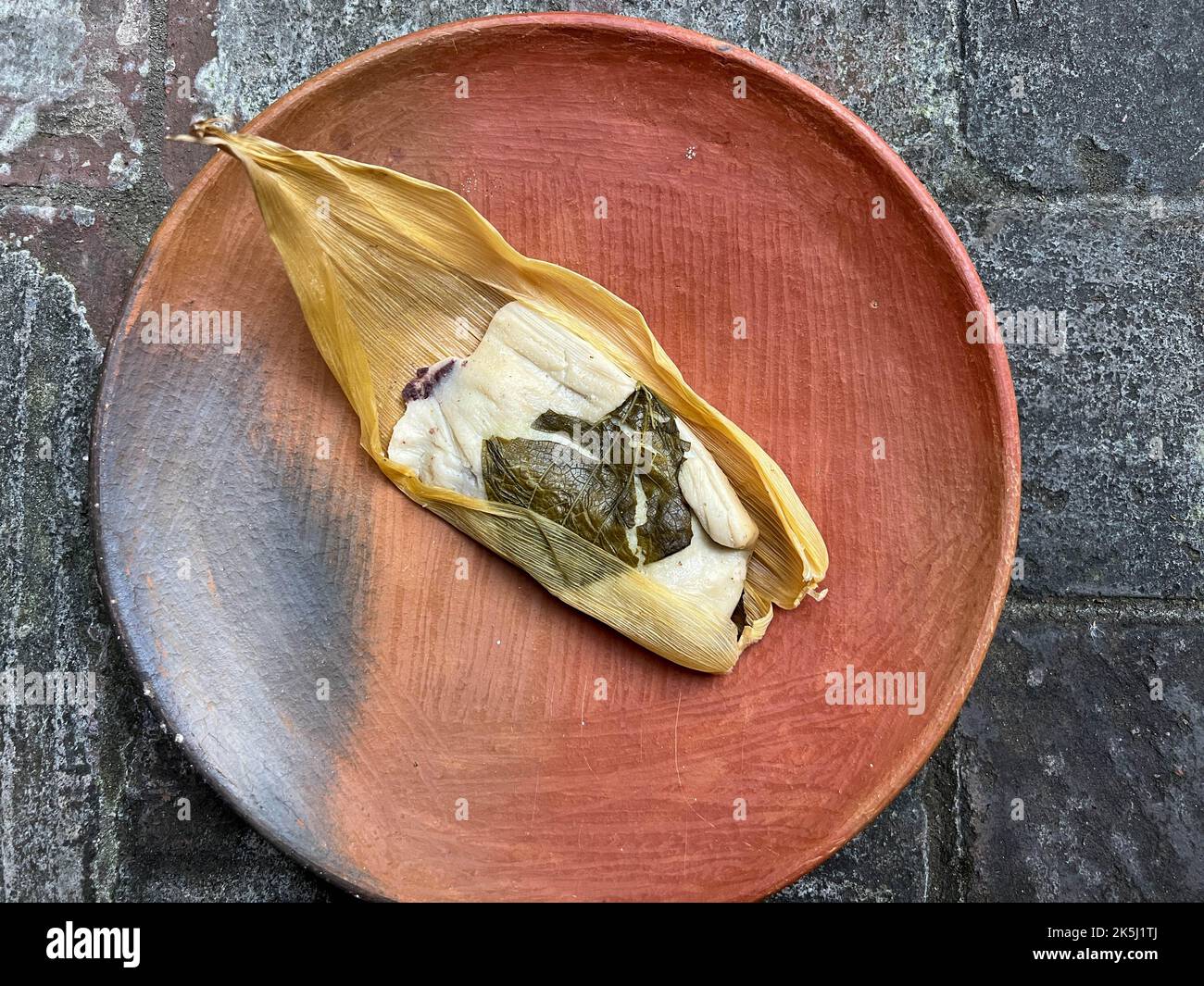 One Oaxacan Tamal on a plate made with masa and hierba santa Stock ...