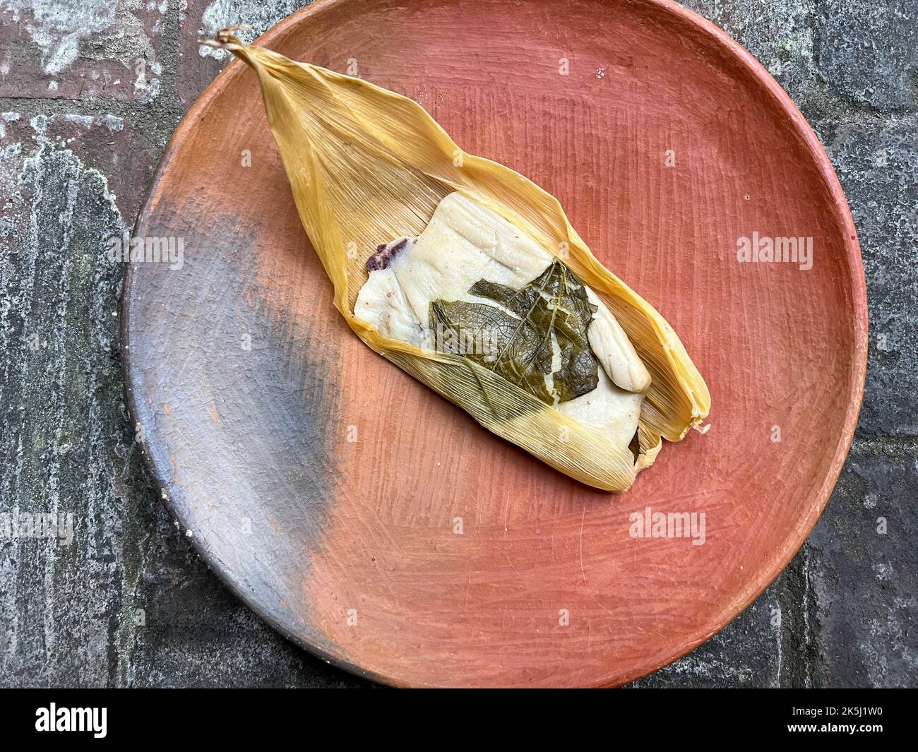 One Oaxacan Tamal on a plate made with masa and hierba santa Stock ...