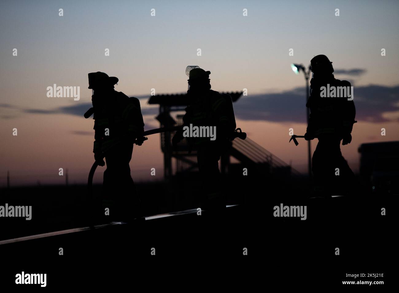 Firefighters from the 92nd Civil Engineer Squadron adjusts participate ...