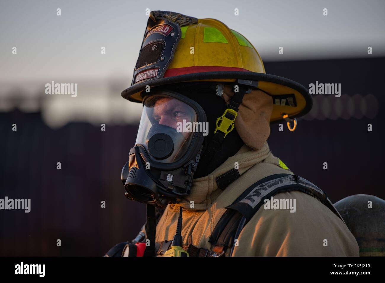 A firefighter from the 92nd Civil Engineer Squadron listens to a safety ...