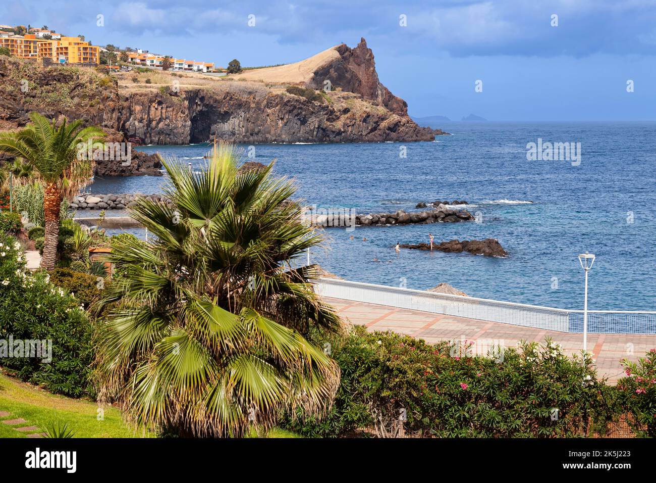 View of the beach promenade and cliffs at Canico, Madeira, Portugal ...