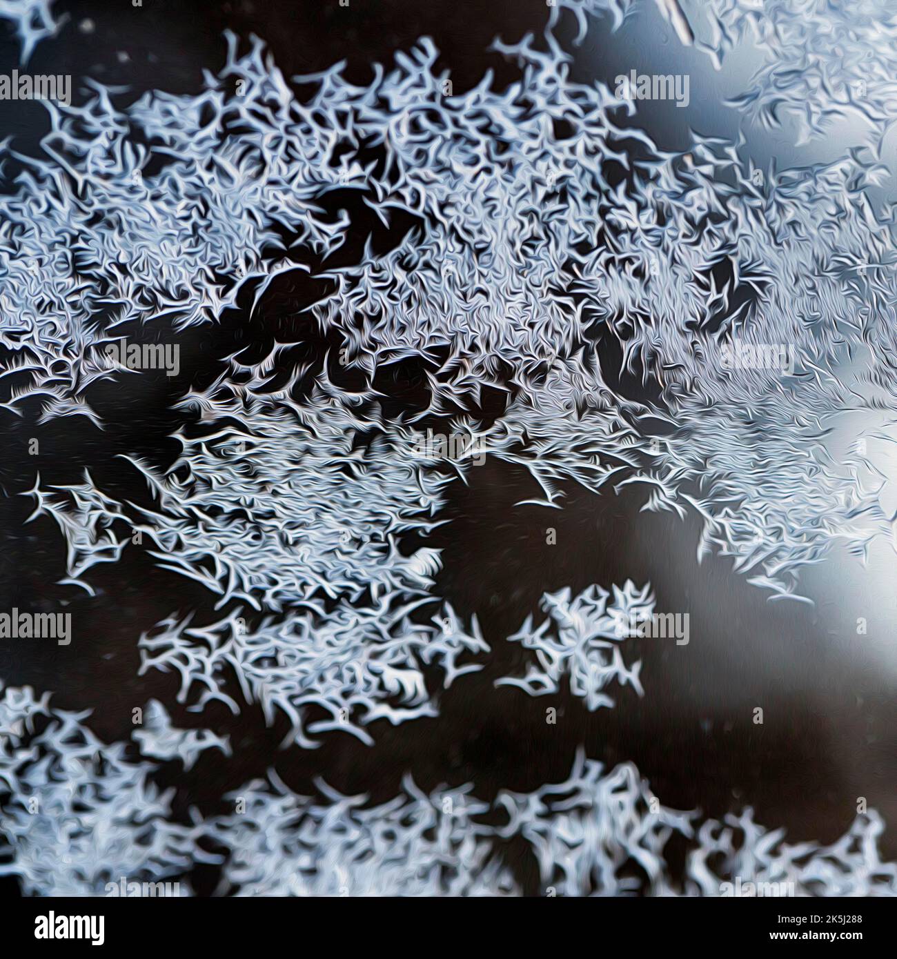 Ice crystals, snow crystals on glass, window pane of a flat in winter ...