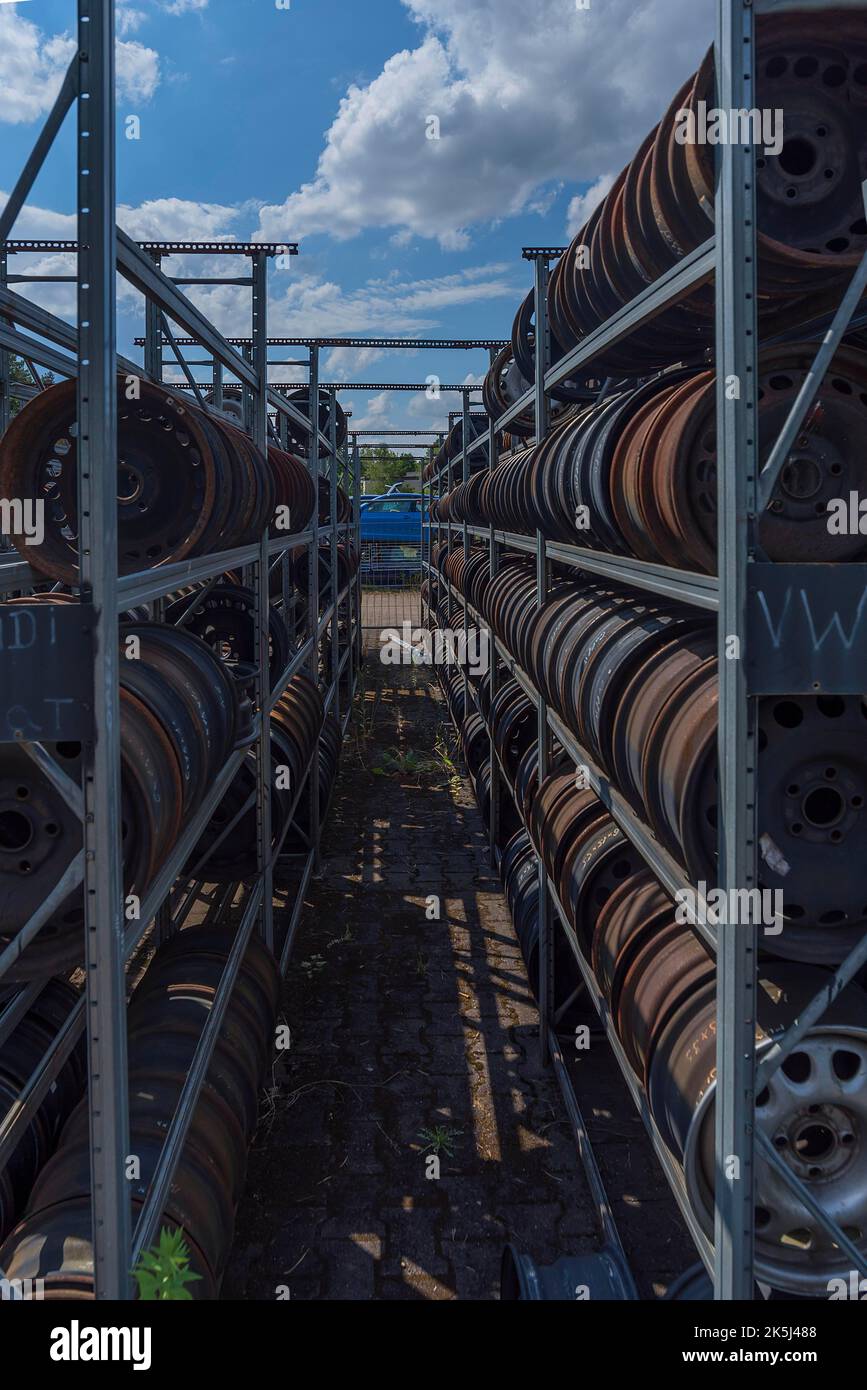 Shelf storage with sorted car rims at a scrap yard, Bavaria, Germany ...