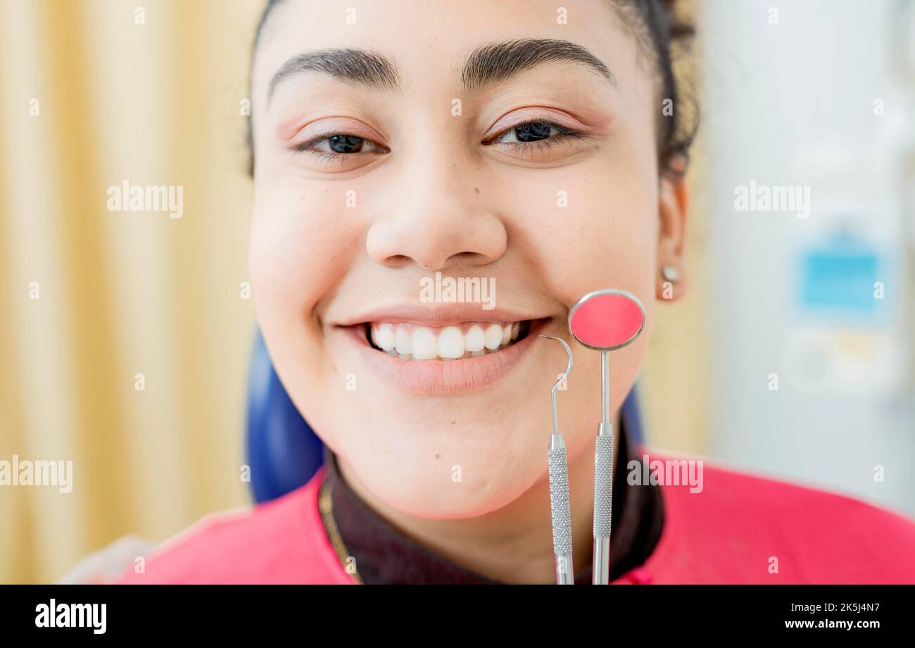 Dental smile young woman with dentist tools. Patient with perfect smile ...