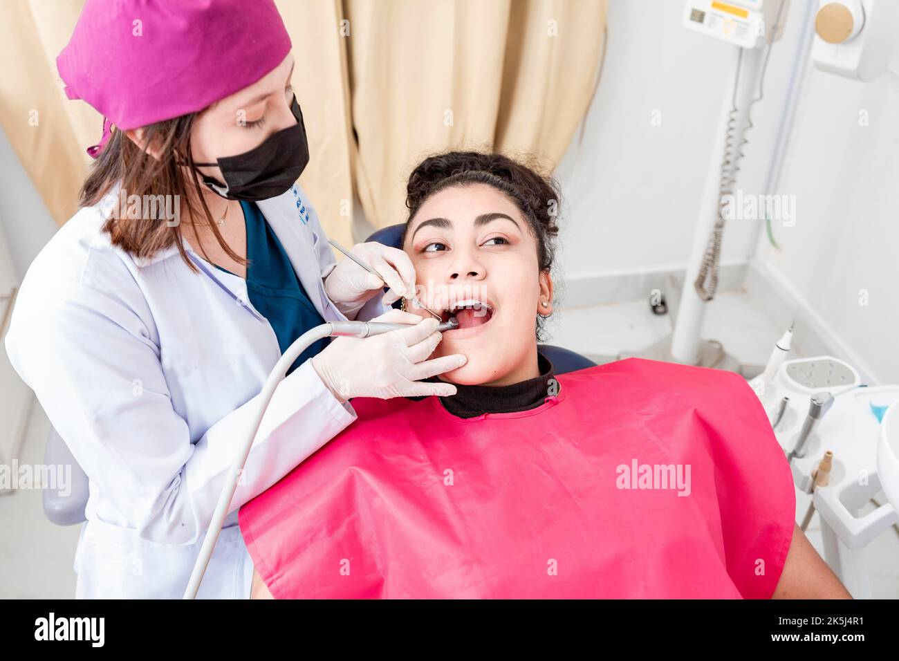 A dentist cleaning a patient mouth with a drill. Stomatologist cleaning a patient's teeth, Close ...