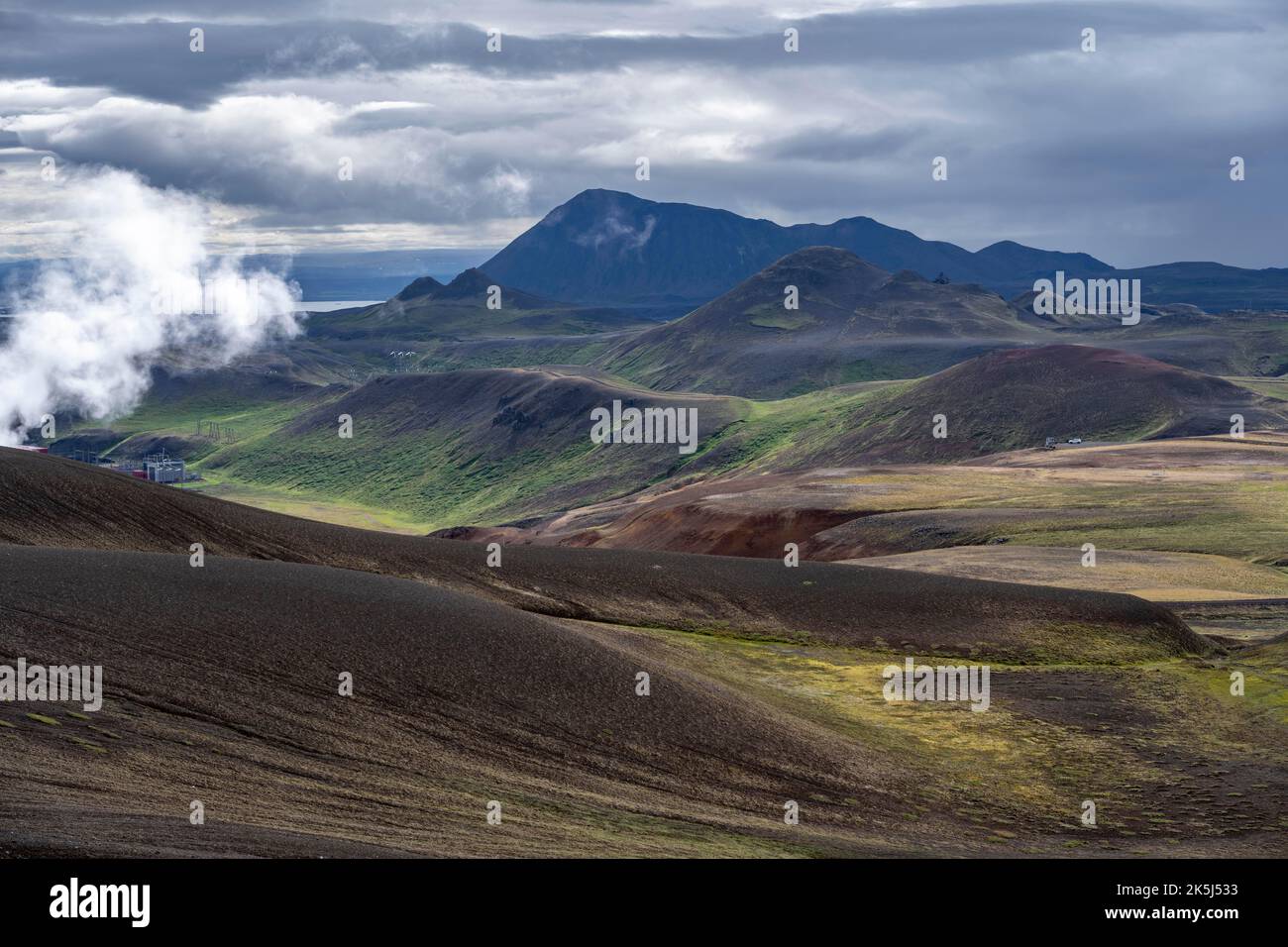 Volcanic landscape with colourful hills, steam of the Krafla geothermal ...