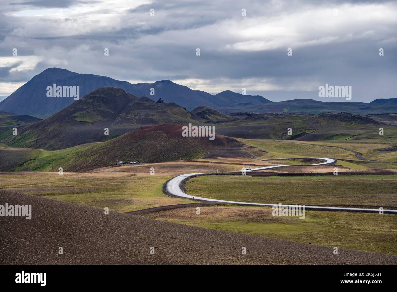 Road through volcanic landscape with colourful hills, Krafla geothermal ...