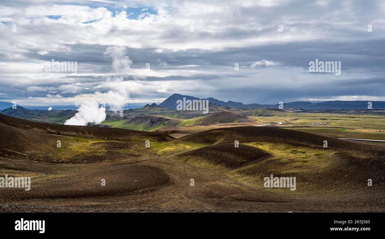 Volcanic landscape with colourful hills, steam of the Krafla geothermal ...