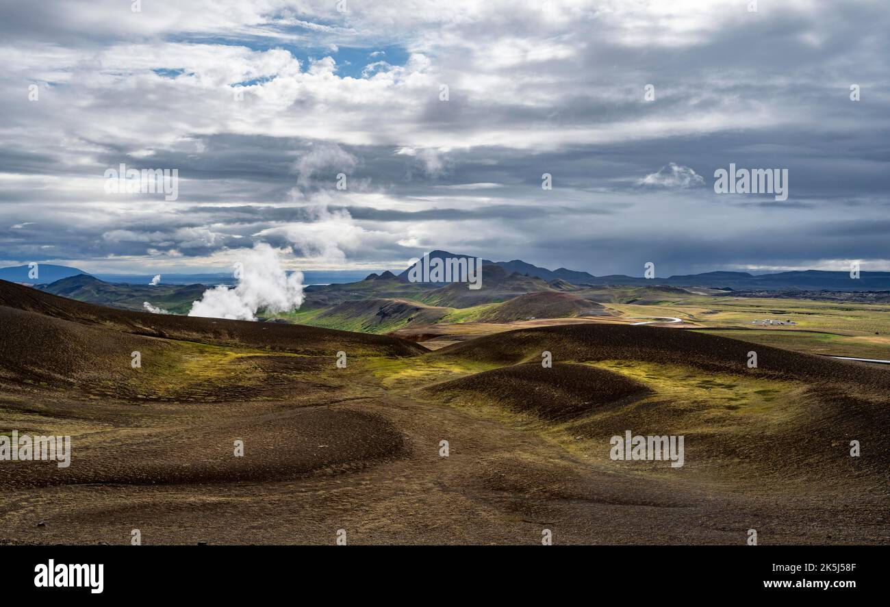 Volcanic landscape with colourful hills, steam of the Krafla geothermal ...