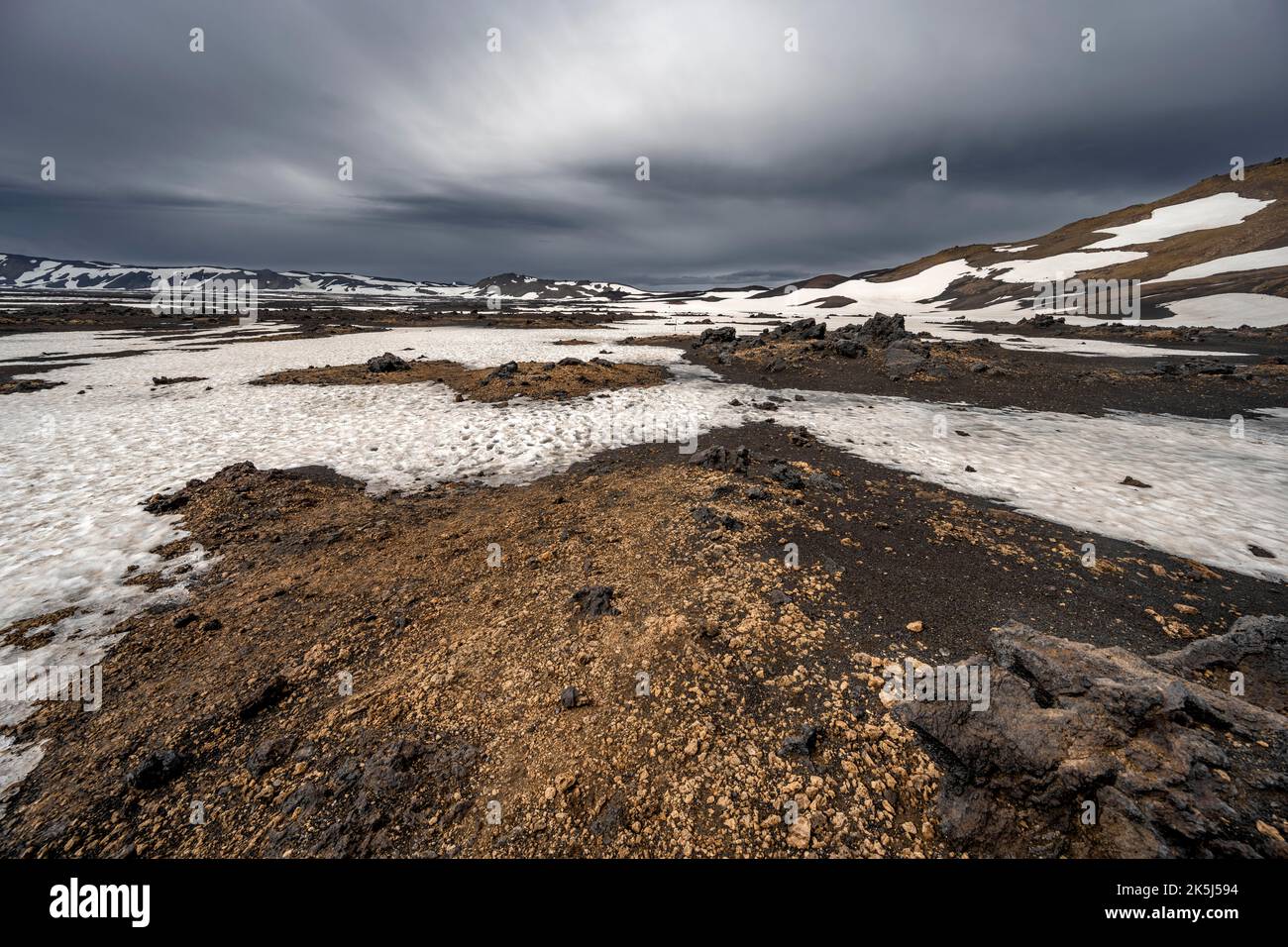 Snow-covered volcanic landscape with tuff and petrified lava, crater of ...