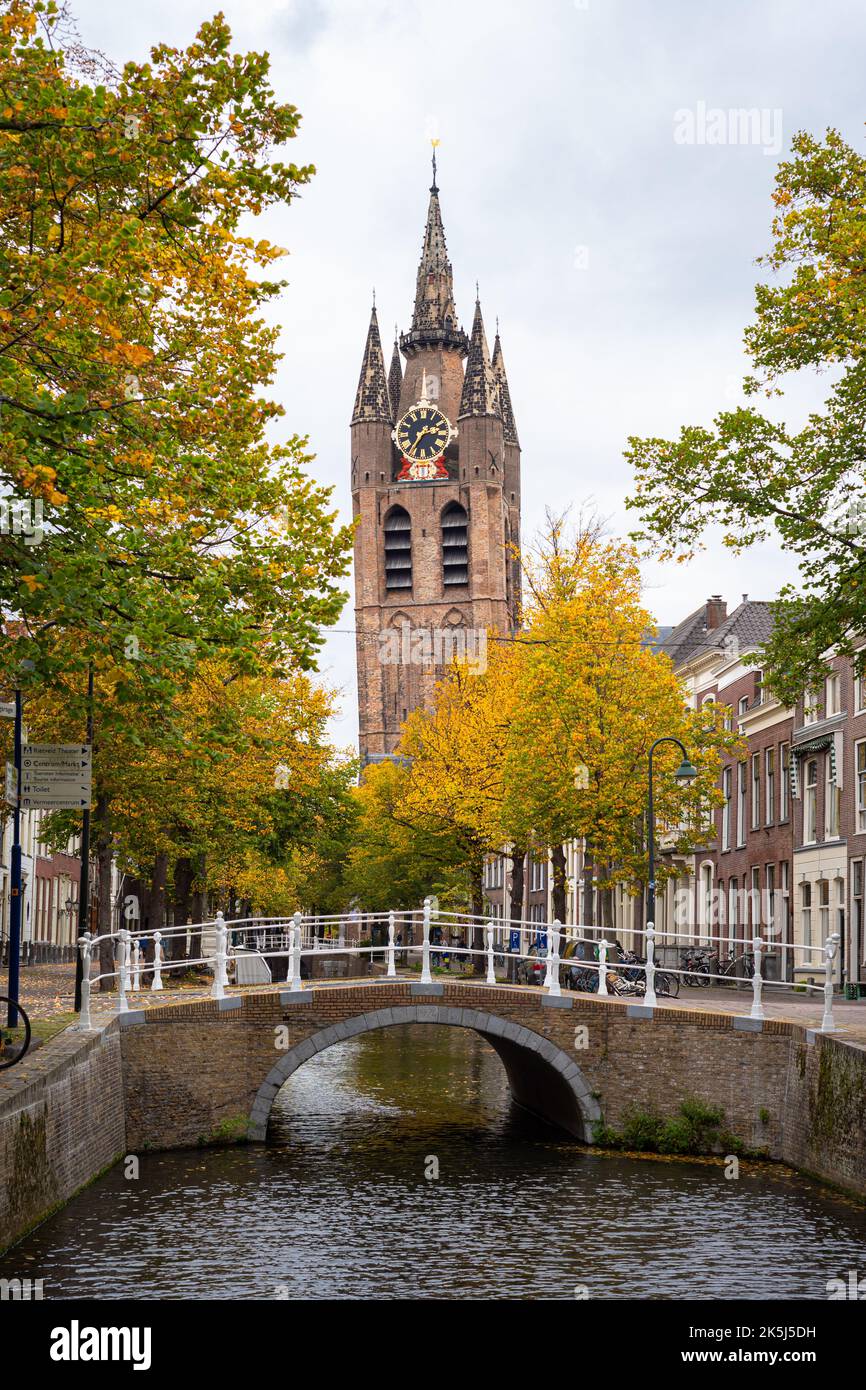 Canal and bridge with trees in autumn leaf colors. In the background ...