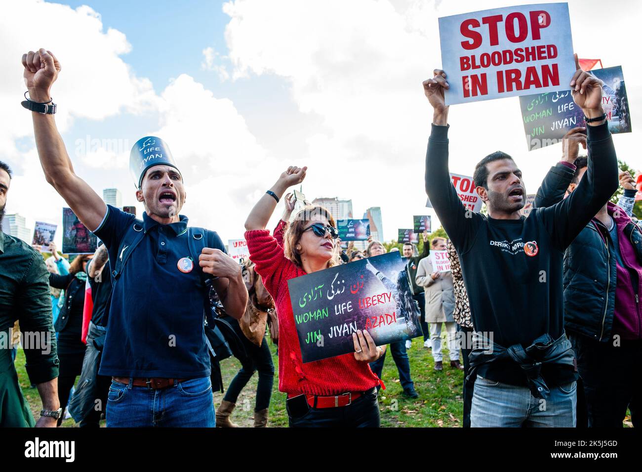 Iranian women and men are seen shouting slogans during the ...