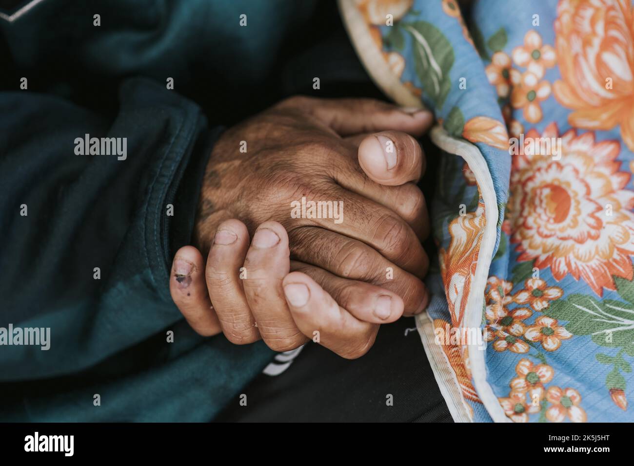 Homeless man holding his hands with blanket Stock Photo - Alamy