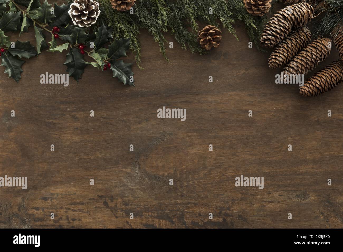 Holly branches with cones table Stock Photo - Alamy