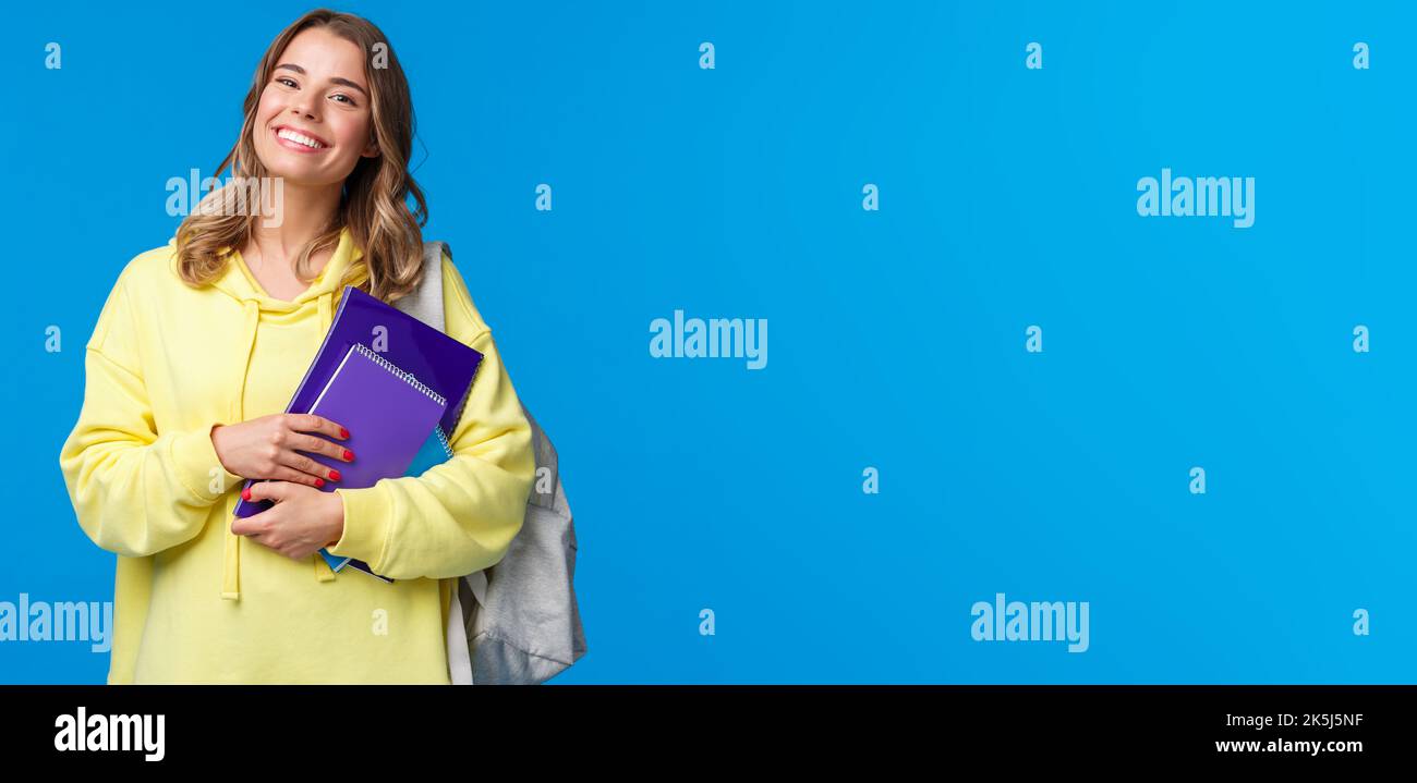Charismatic joyful european female carry backpack and notebooks as ...