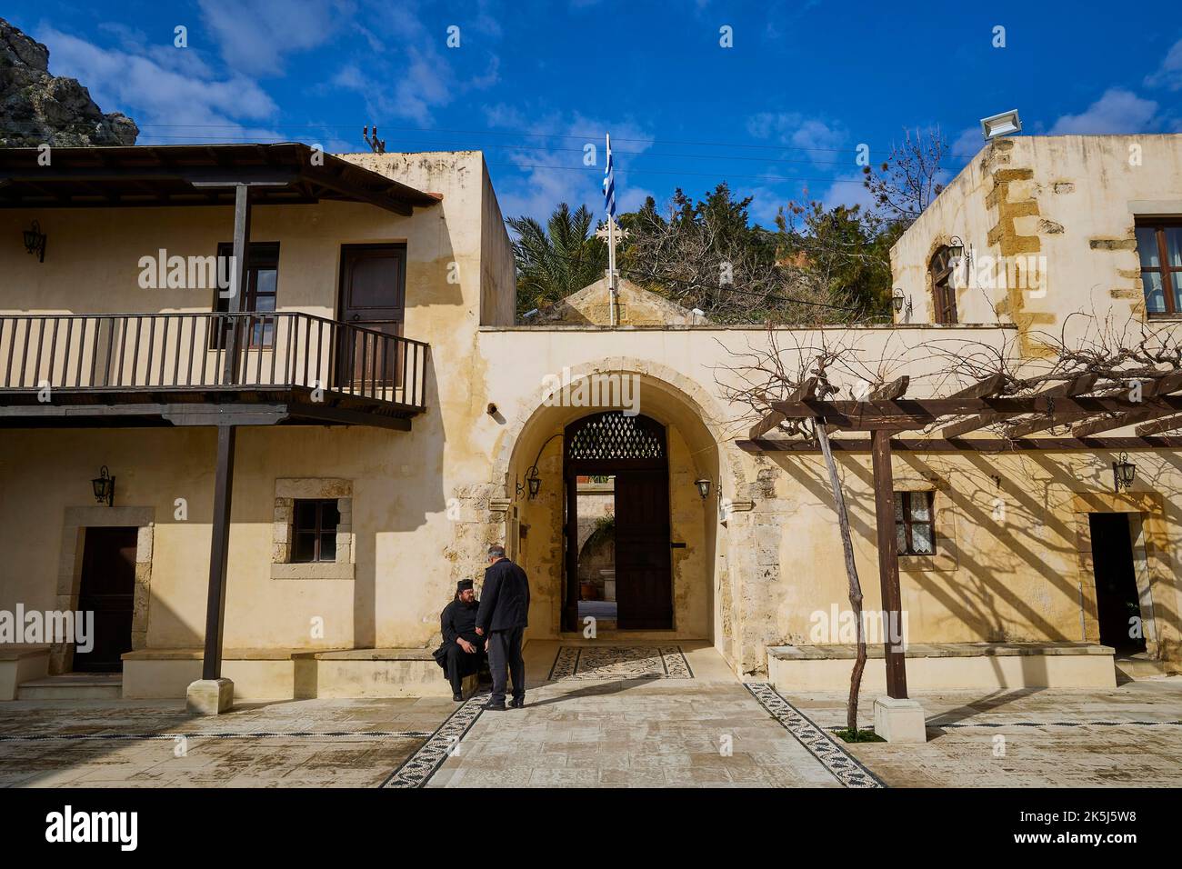 Inner courtyard, view to the entrance, monk sitting, man standing ...