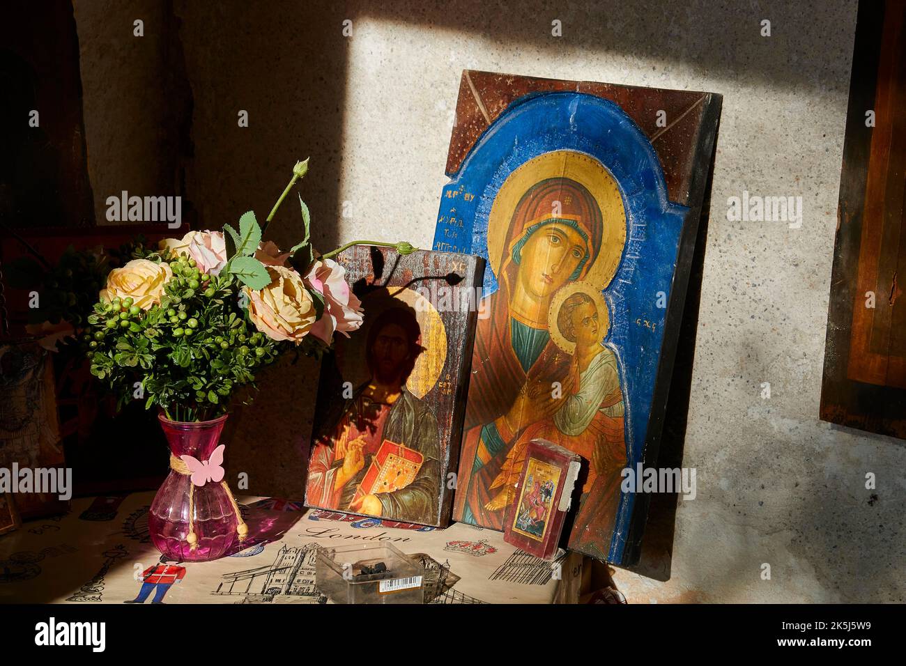 Wooden icons, Mother of God, Christ, bouquet of flowers in vase, close ...