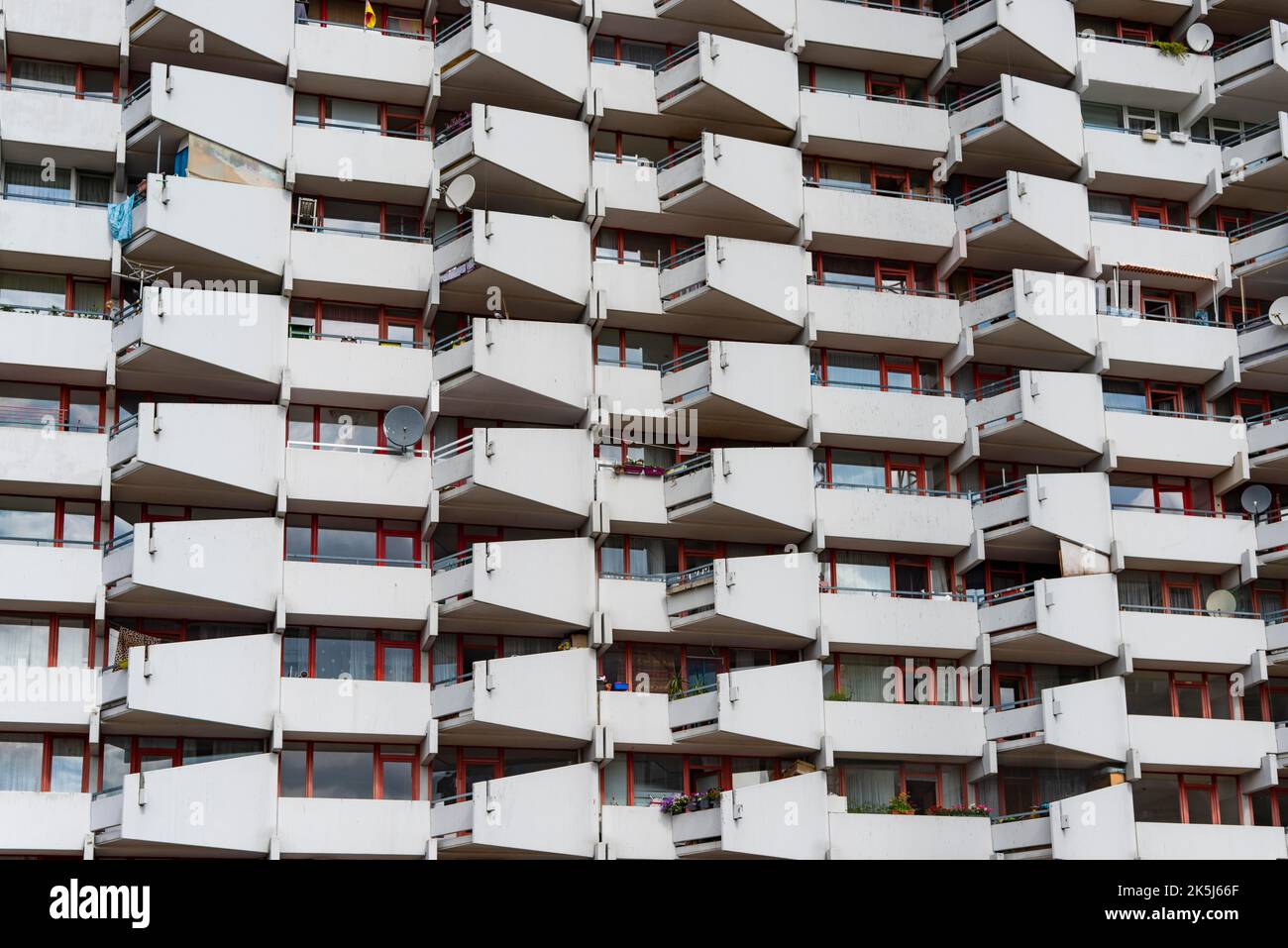 High-rise residential building with balconies and satellite dishes ...