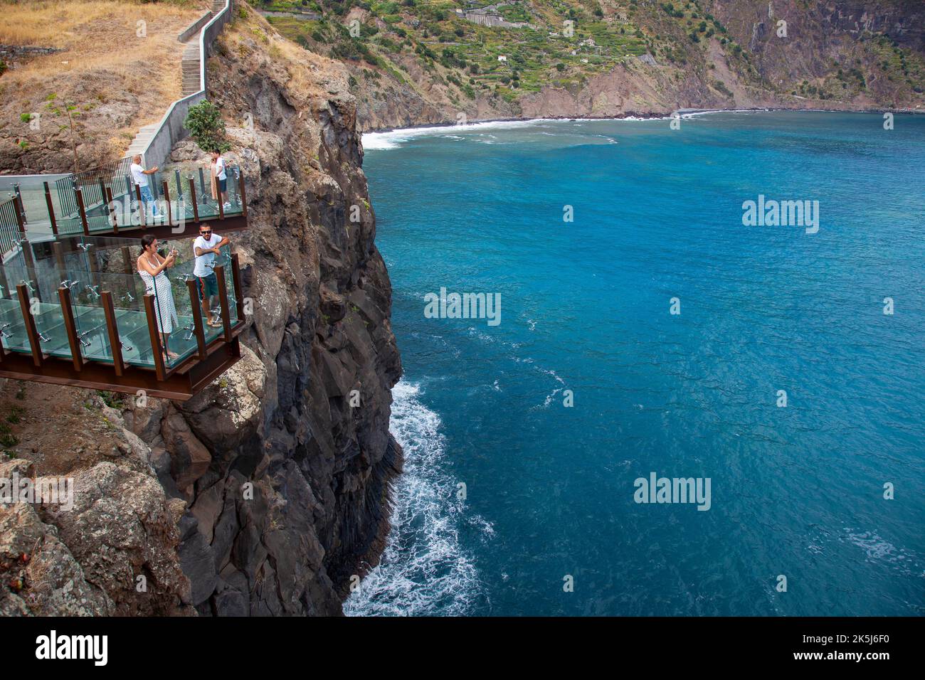 Tourists look at view from Glass bottomed skywalk, Cabo Girao, Funchal ...