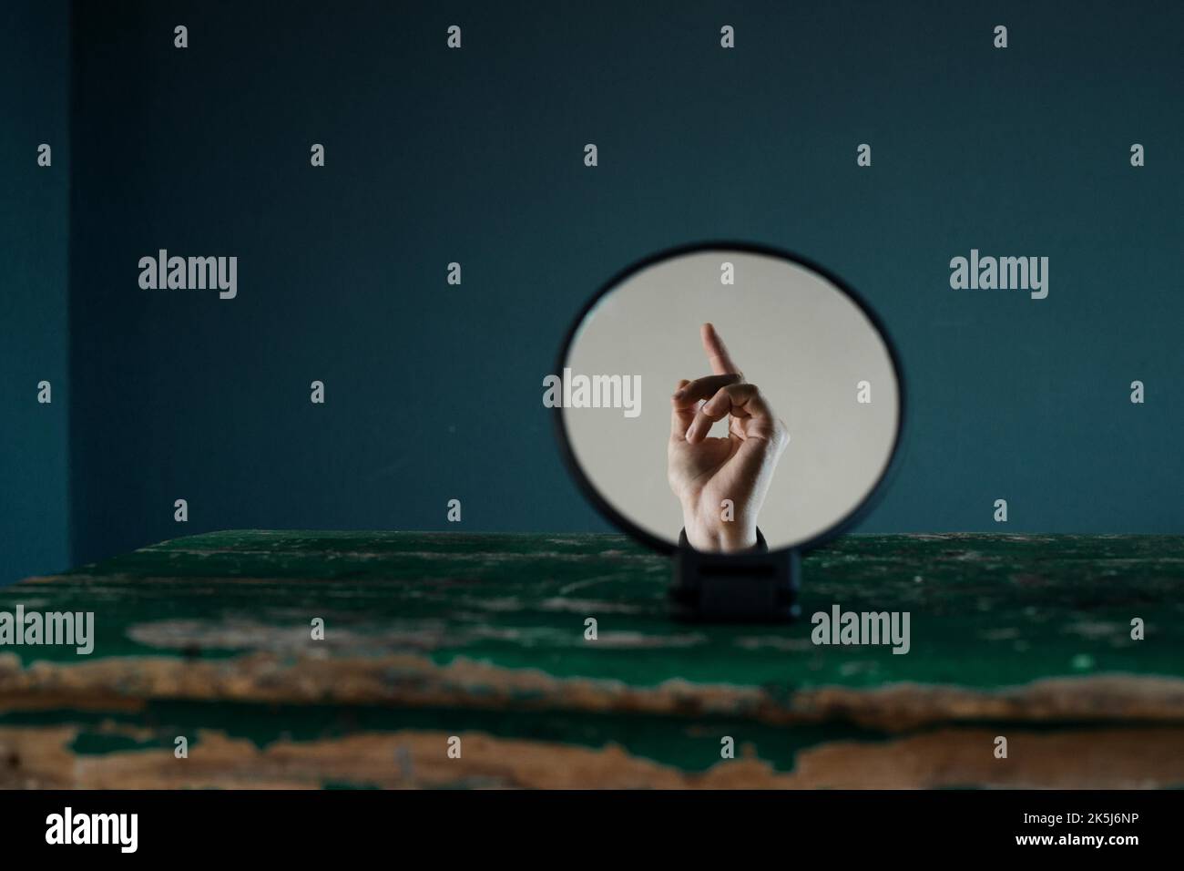 Mirror image with hand, interior shot Stock Photo - Alamy