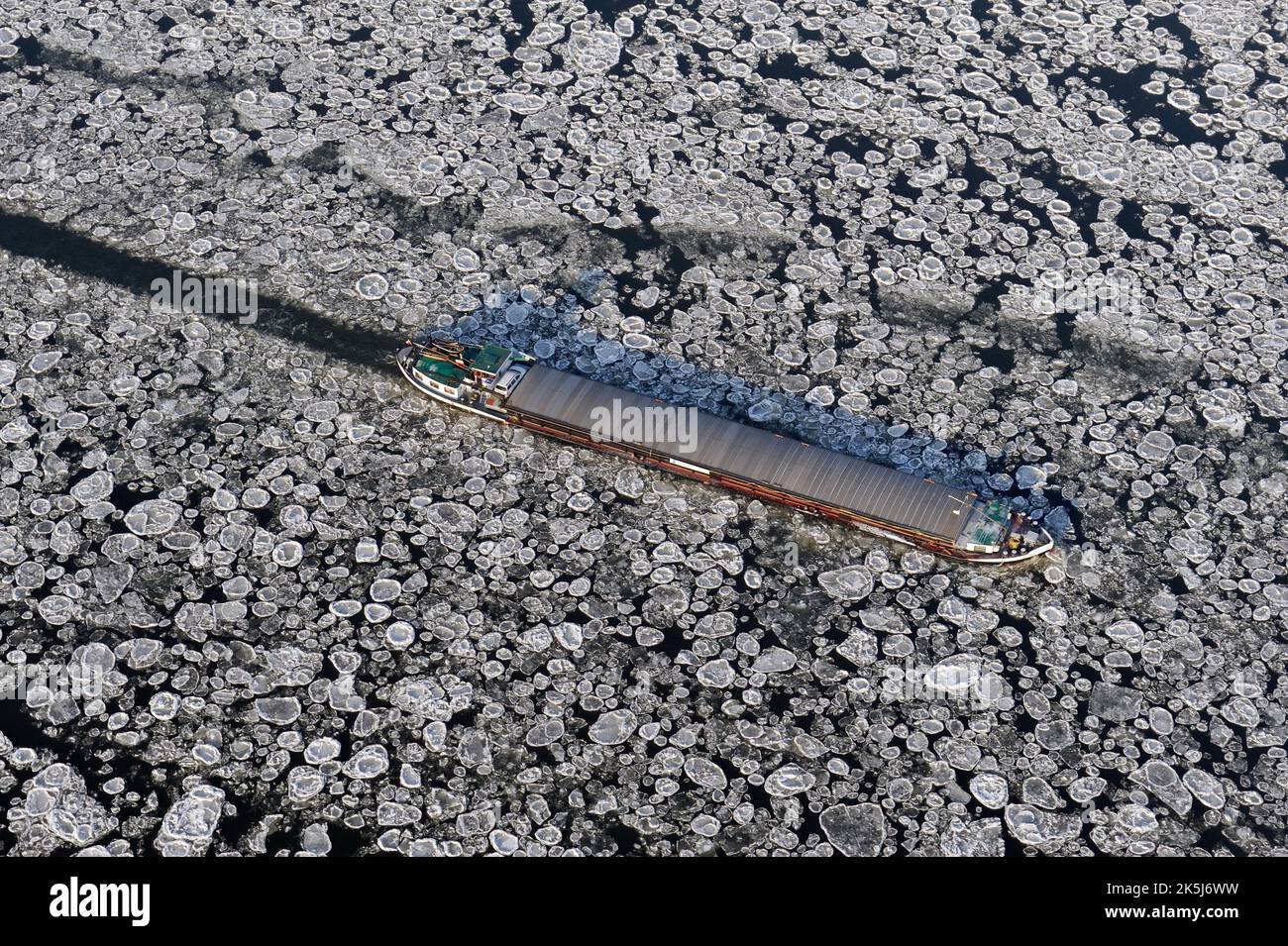 Aerial view of a barge during ice conditions on the Elbe, transport ...