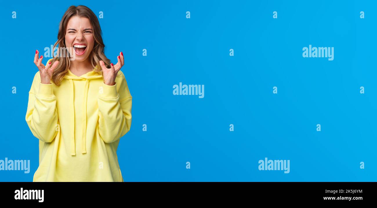 Funny and emotive cute blond european girl in yellow hoodie want ...