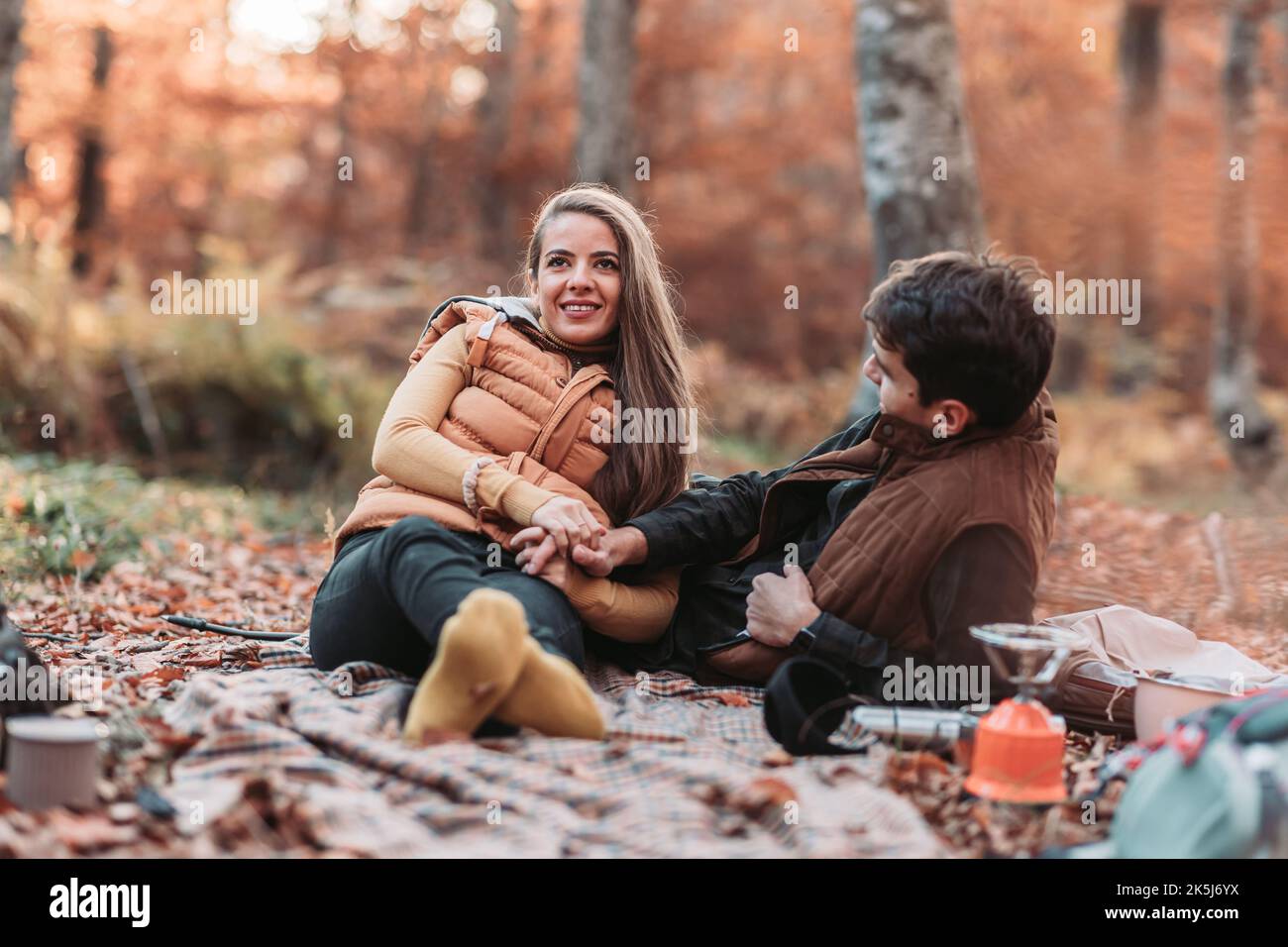 Romantic couple having a picnic in the woods. Autumn vibes Stock Photo ...