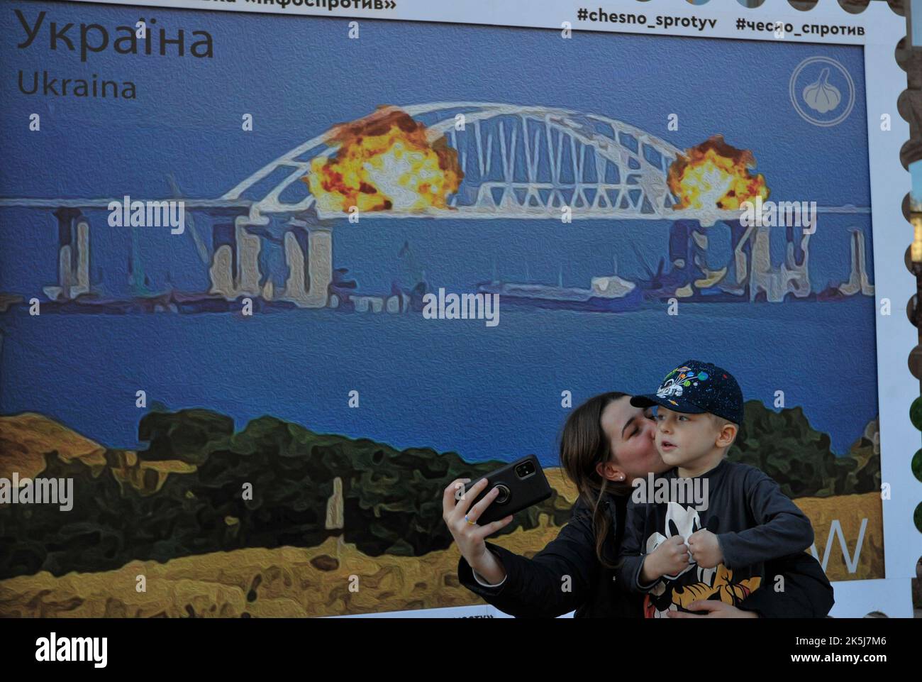 Mother and child take photos against the background of the stamp layout ...