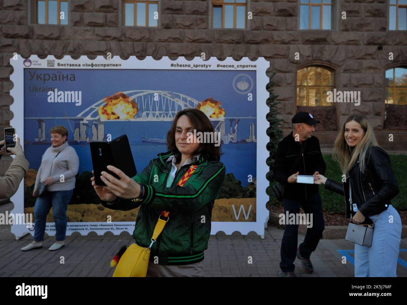 People take photos against the background of the stamp layout, which ...