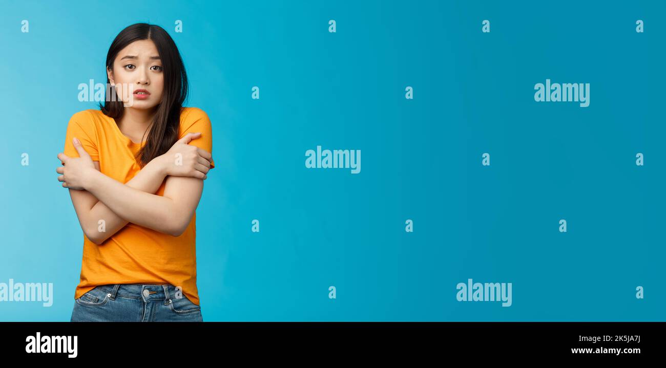 Girl feeling uncomfortable walking light yellow t-shirt, hugging ...