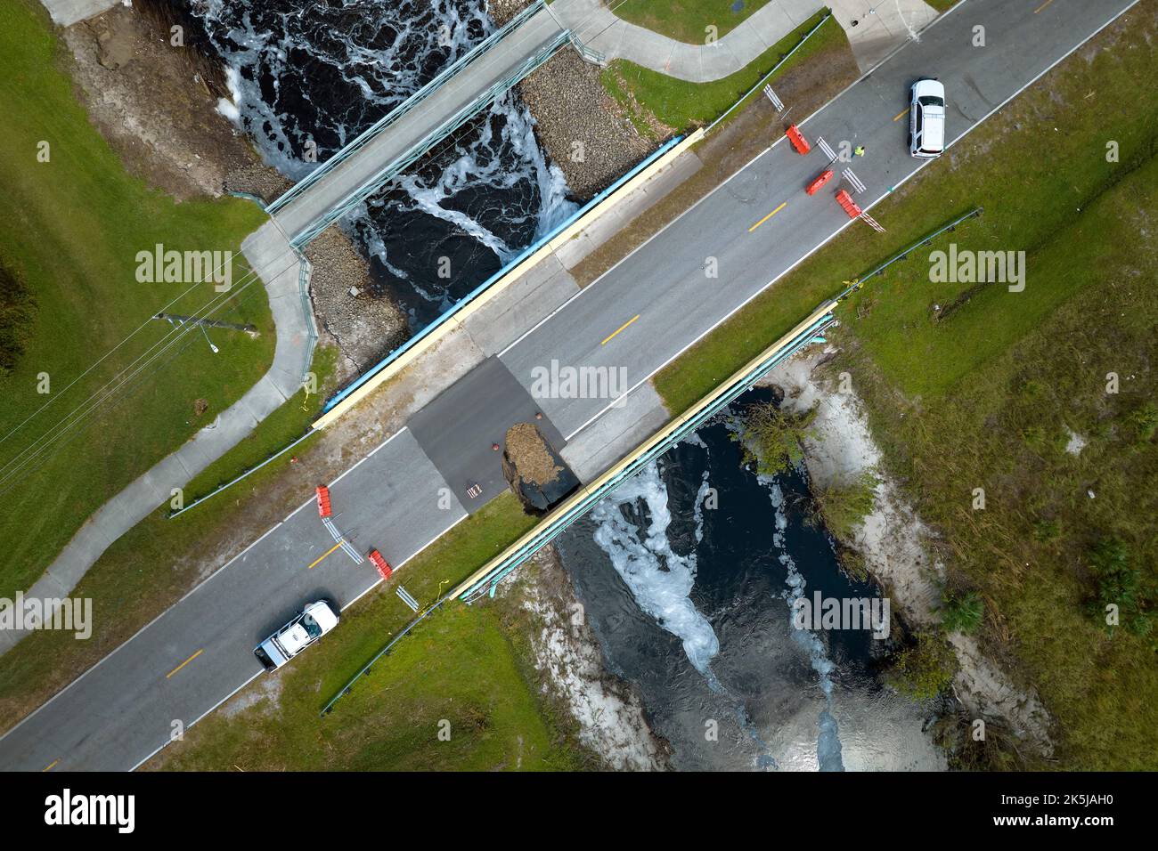 Aerial view of damaged road bridge over river after flood water washed ...