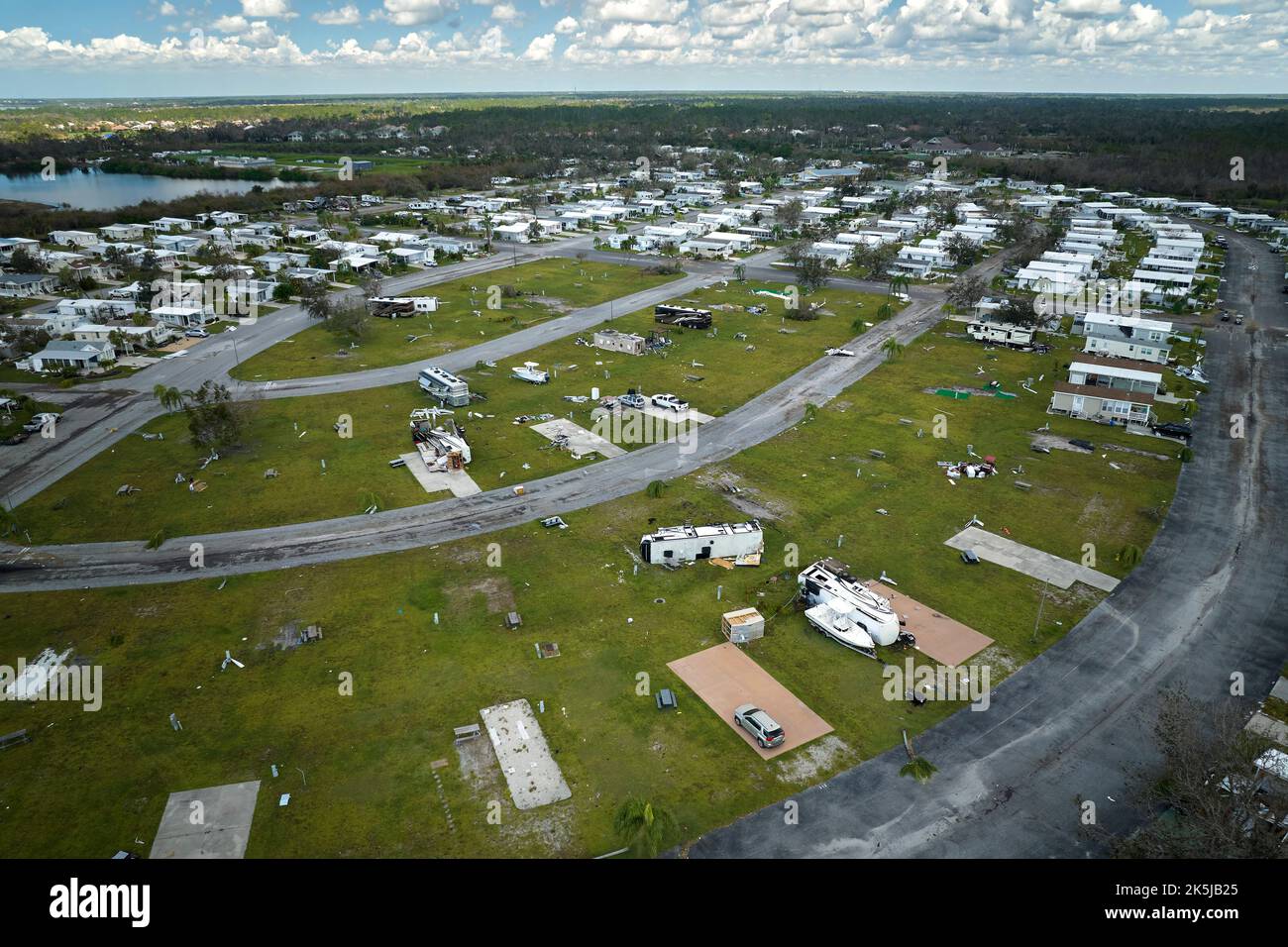 Severely damaged and overturned camper vans and houses after hurricane ...