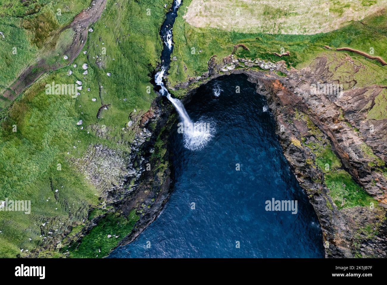 an aerial view of the Mulafossur Waterfall in Gasaladur village on the ...