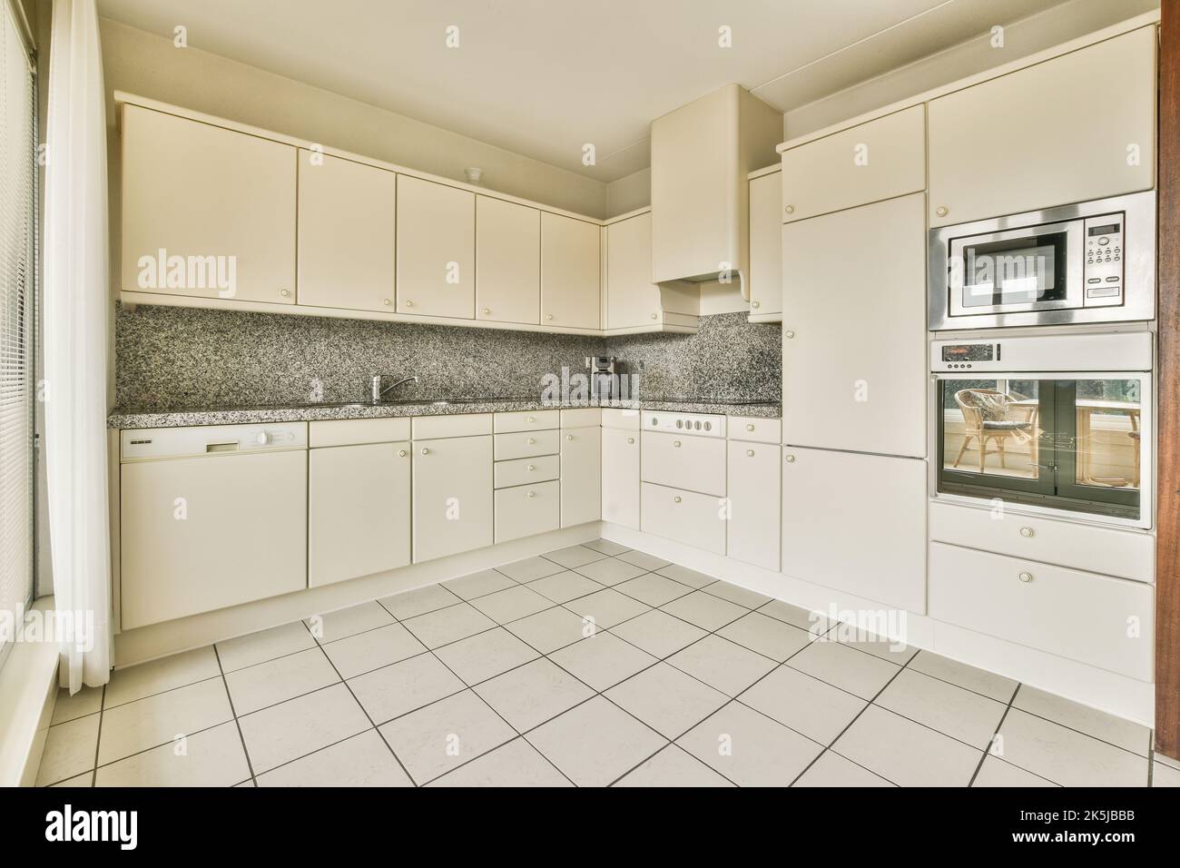 Interior of empty white kitchen with windows and wooden parquet floor ...