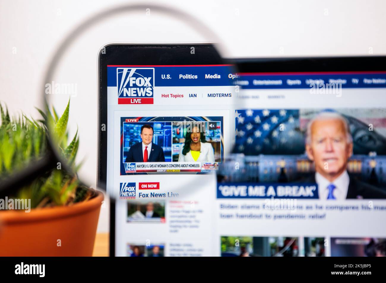 The logo of Fox News on a laptop desktop under a magnifying glass Stock ...