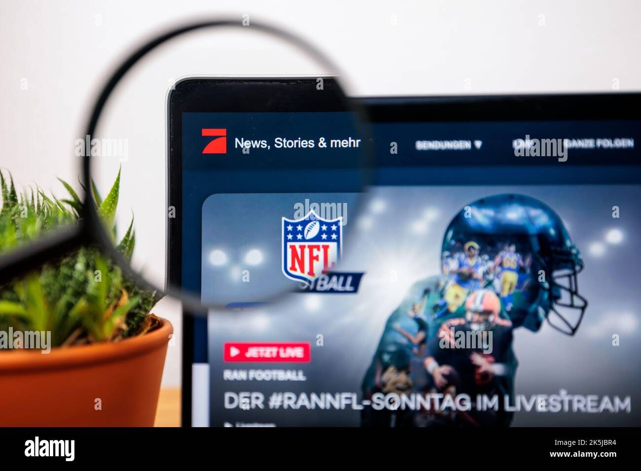 The logo of Pro7 on a laptop desktop under a magnifying glass Stock ...