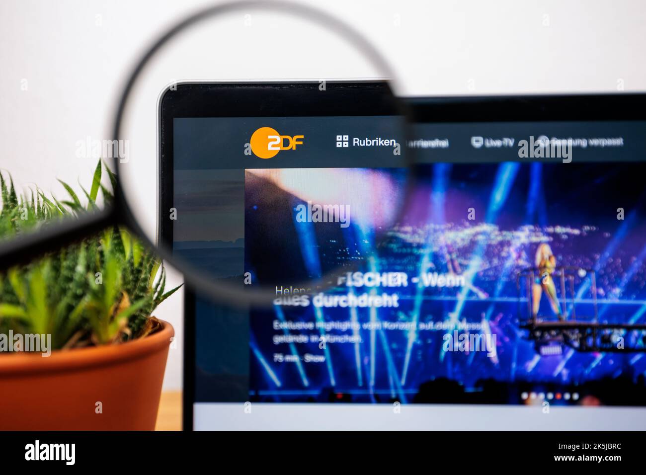 The logo of ZDF on a laptop desktop under a magnifying glass Stock ...