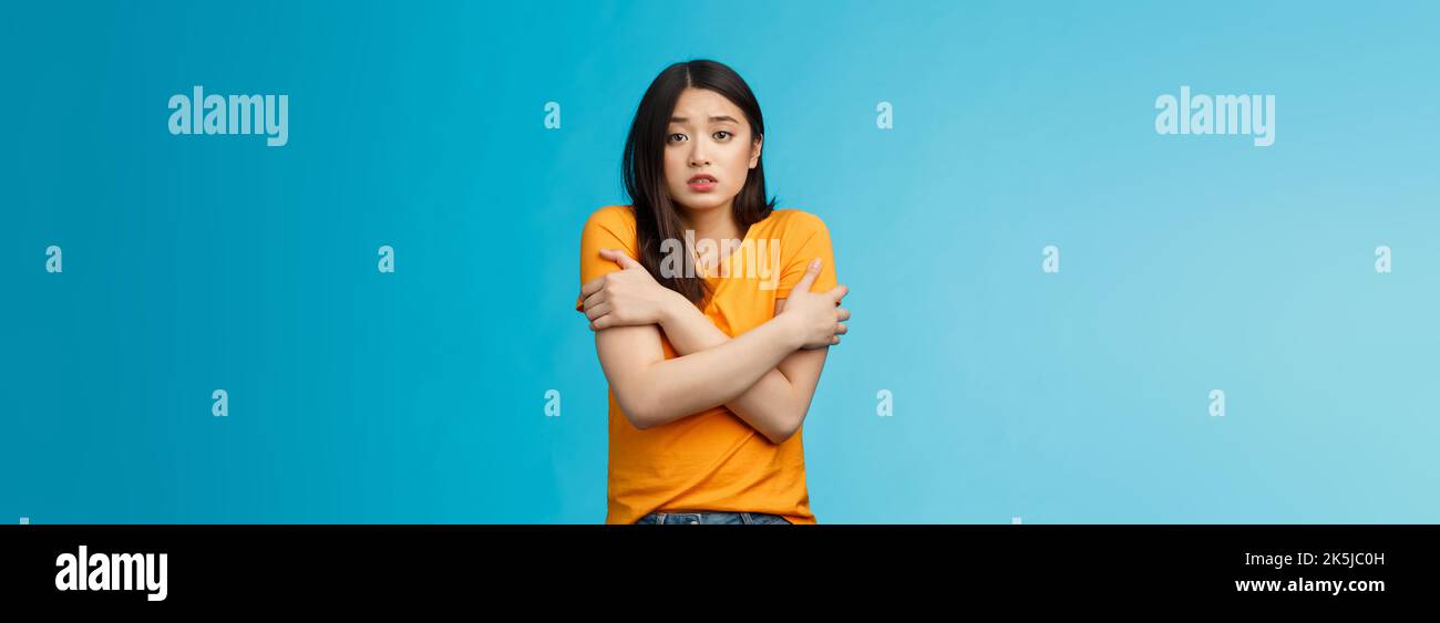 Girl feeling uncomfortable walking light yellow t-shirt, hugging ...