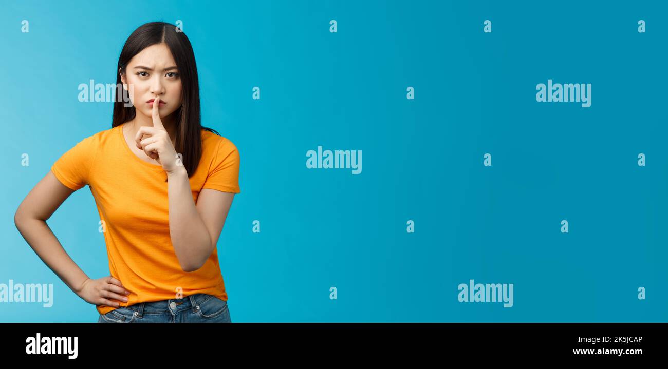 Hush keep quiet, behave well. Serious-looking strict asian elder sister ...