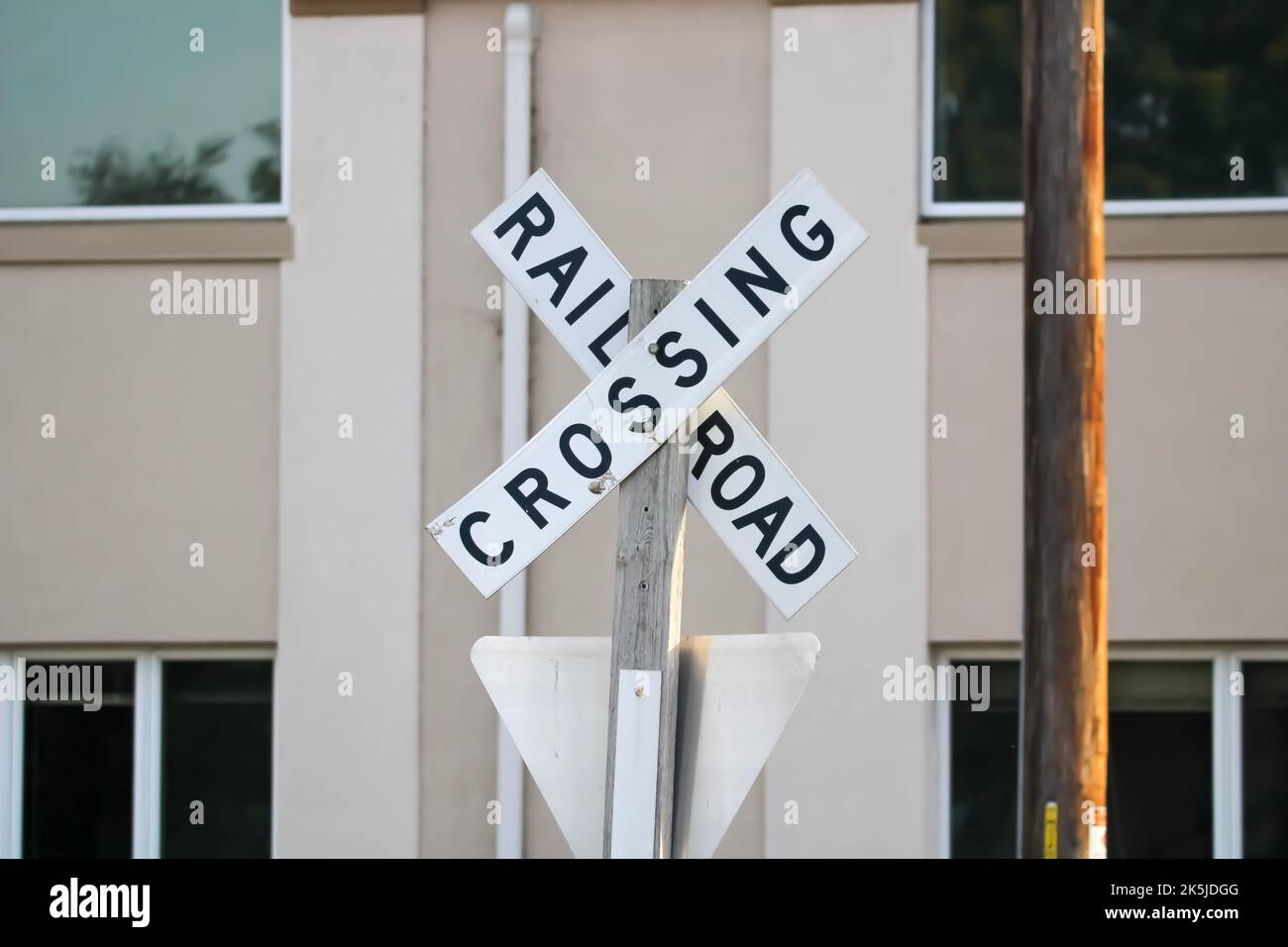 A Railroad Crossing Sign in a street Stock Photo - Alamy