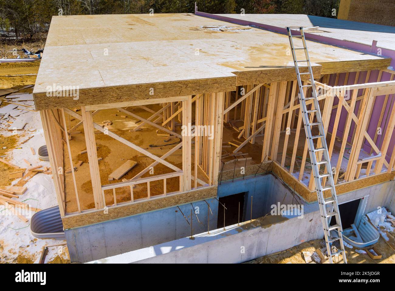 An under construction beam framing structure home on construction site ...
