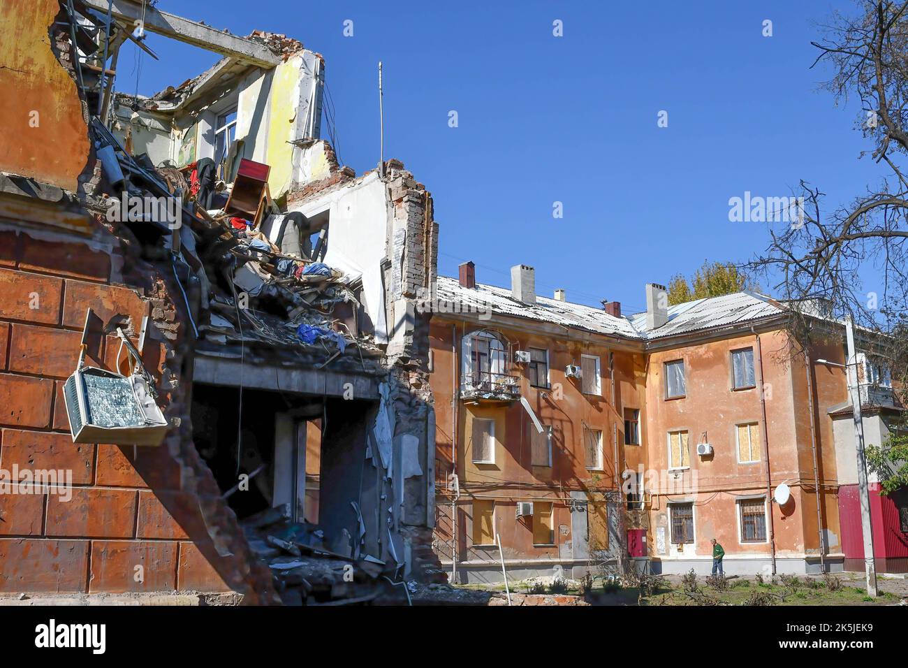 Local resident seen standing at the courtyard of a building heavily ...