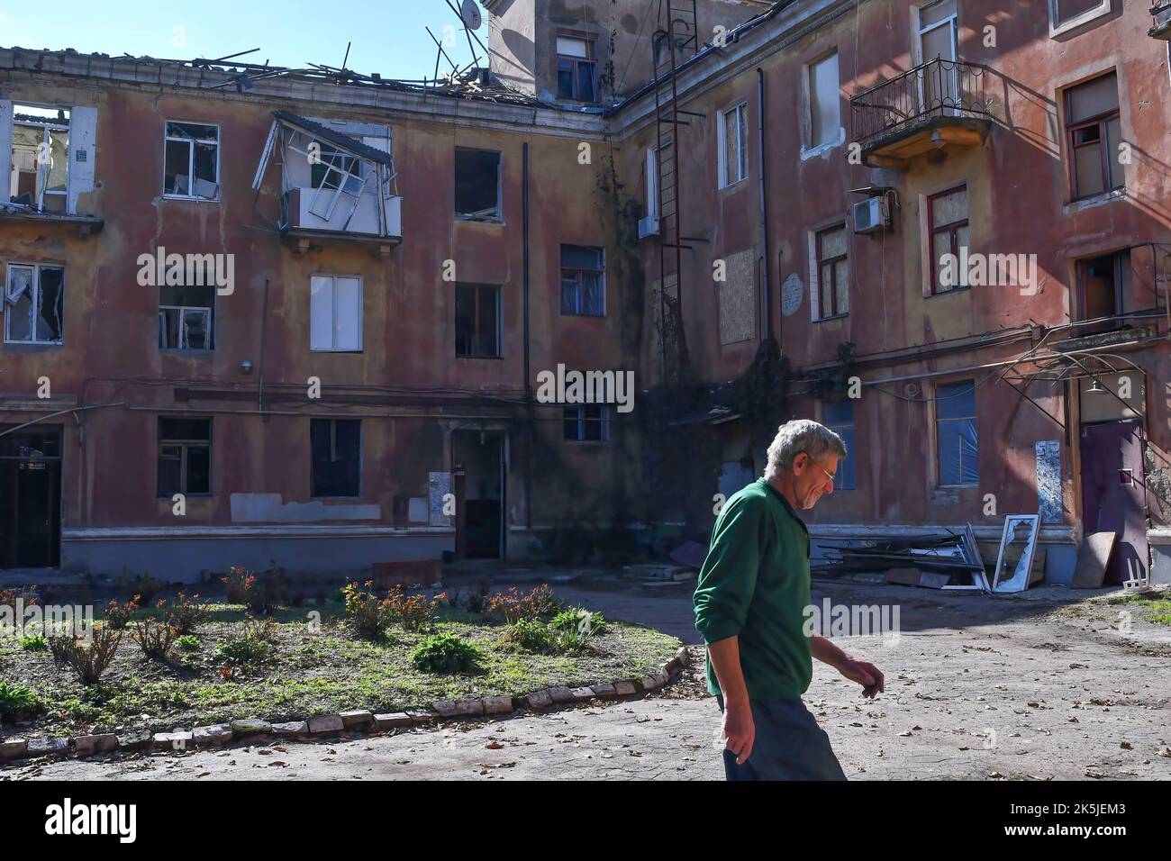 Local resident walks at the courtyard of a building heavily damaged by ...