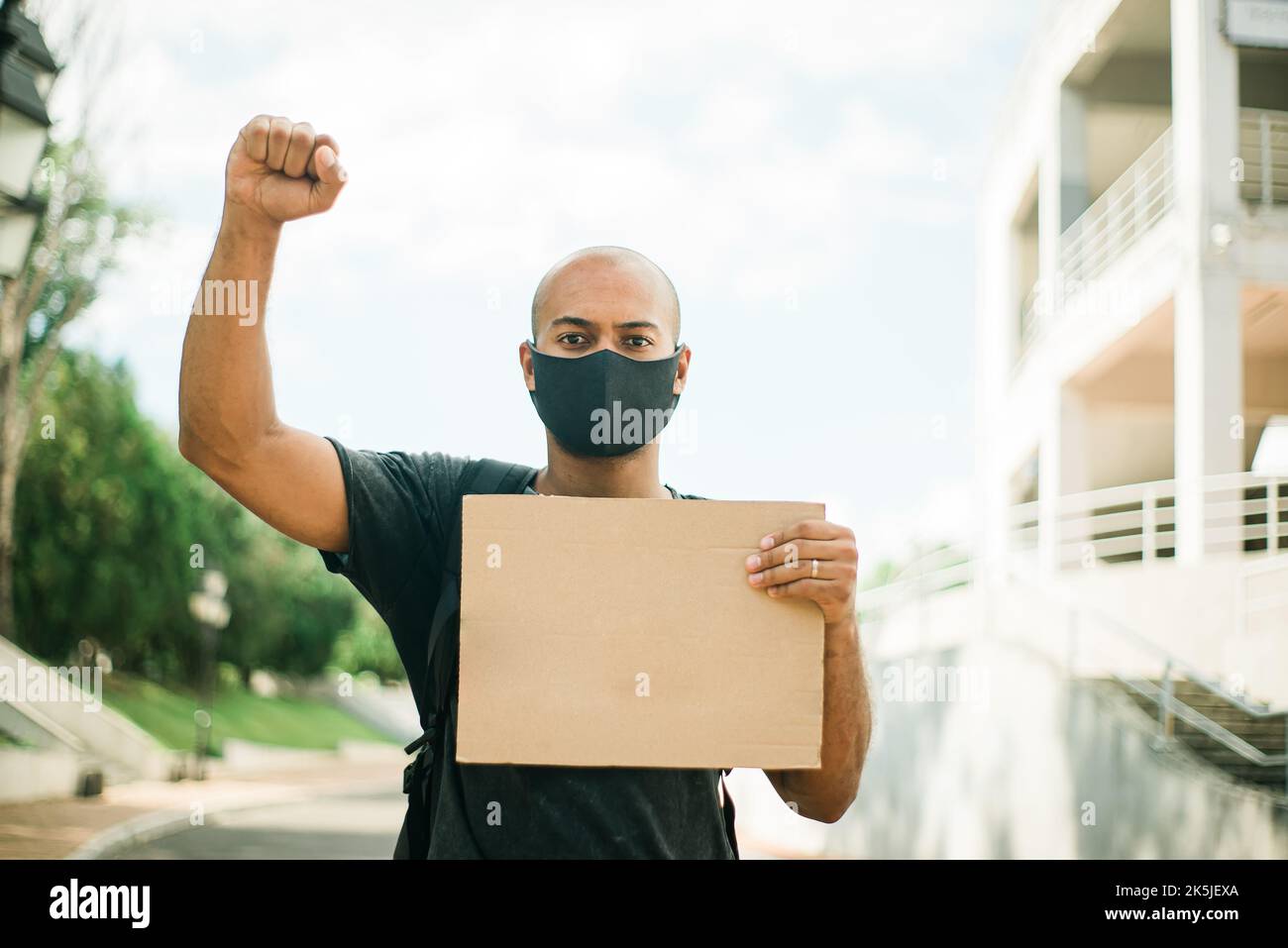 Black man fist above head hi-res stock photography and images - Alamy