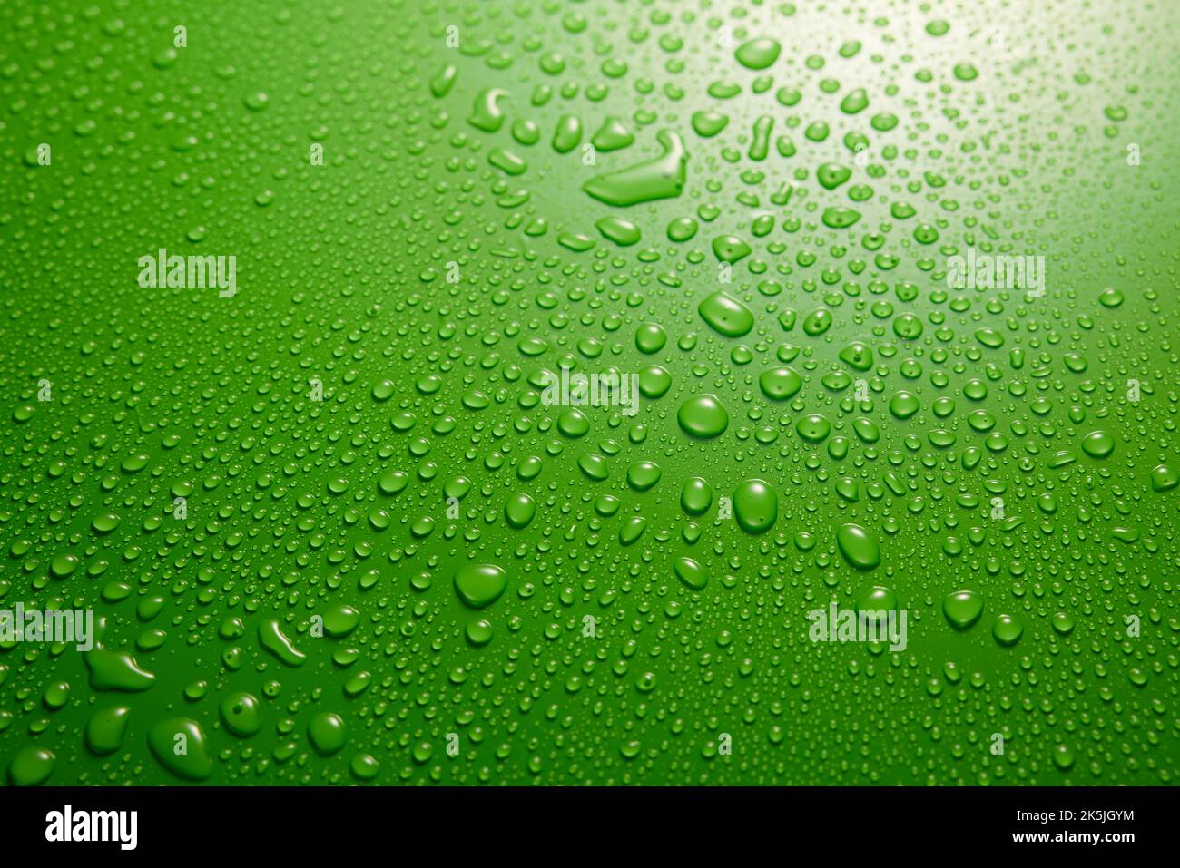 Full frame of clean green background covered with various drops of ...
