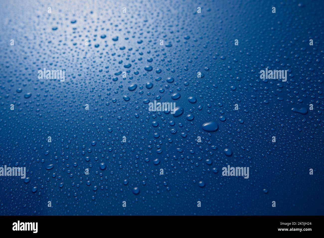 Full frame blue background covered with condense and small transparent ...