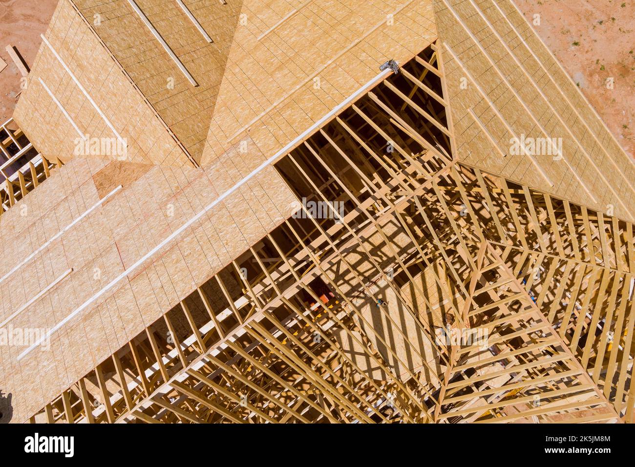 Under construction newly constructed house with roof truss system beams ...