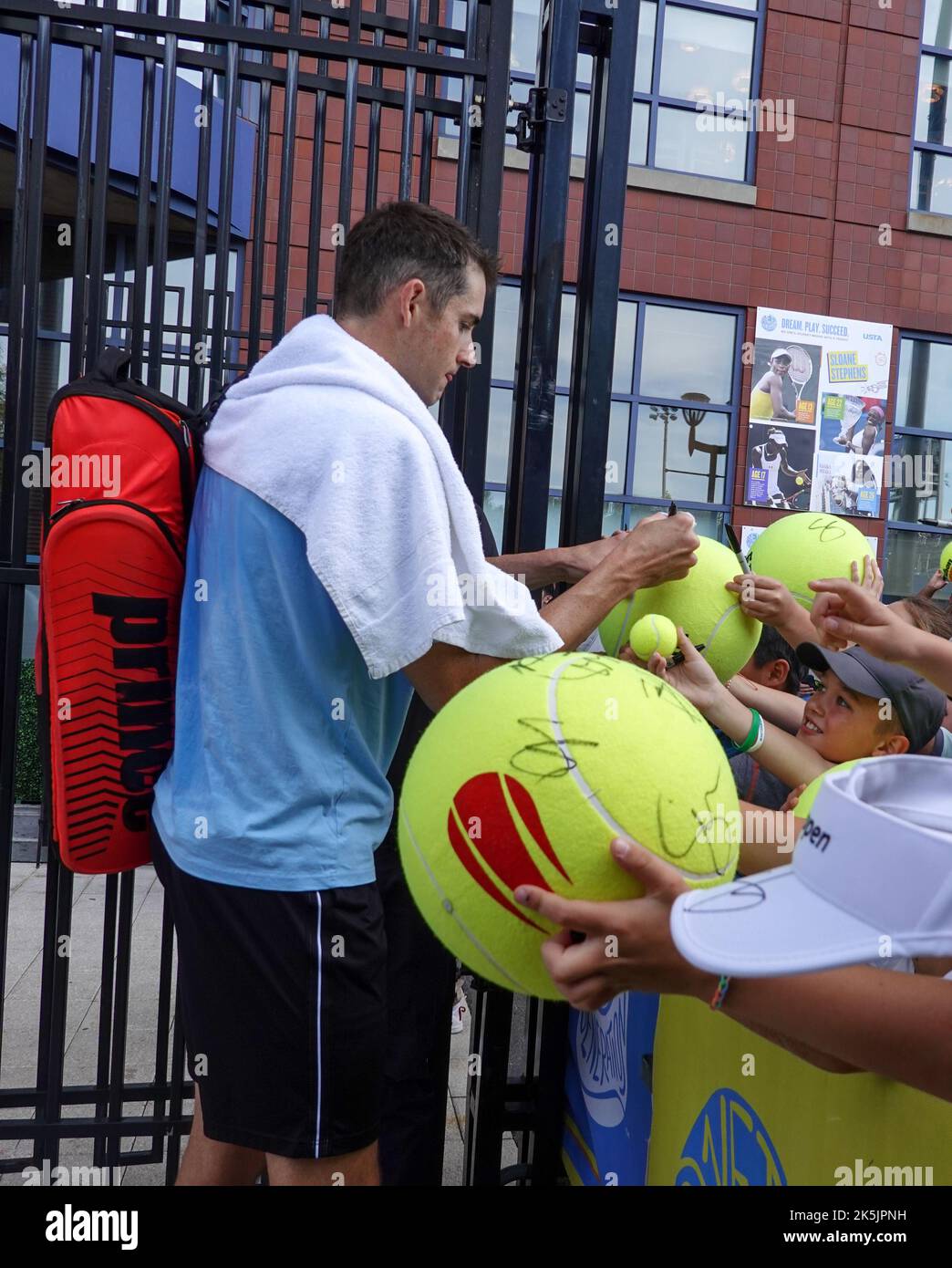 Professional tennis player John Isner of the United States signs ...