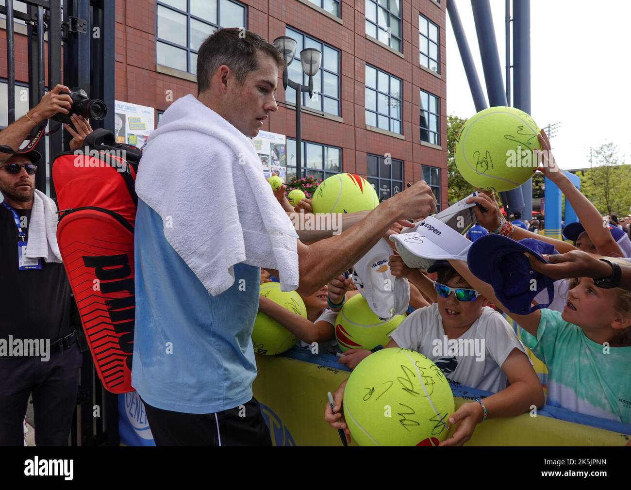 Professional tennis player John Isner of the United States signs ...